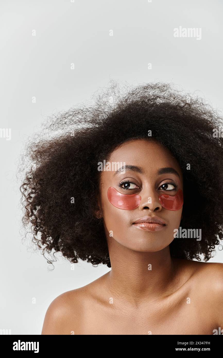 A striking African American woman with curly hair wearing a vibrant red ...