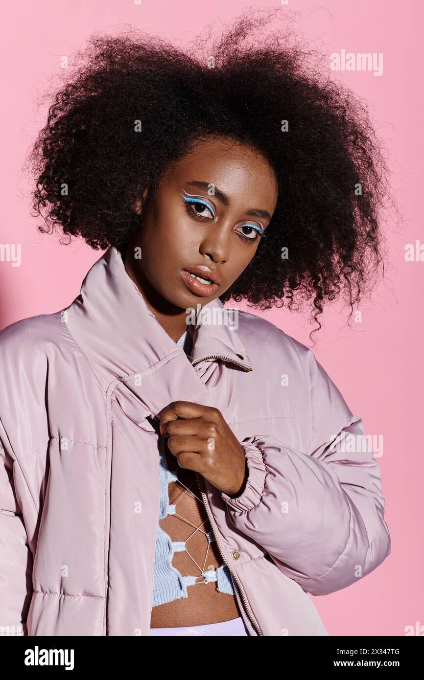 Stylish African American woman with curly afro hair posing in front of ...