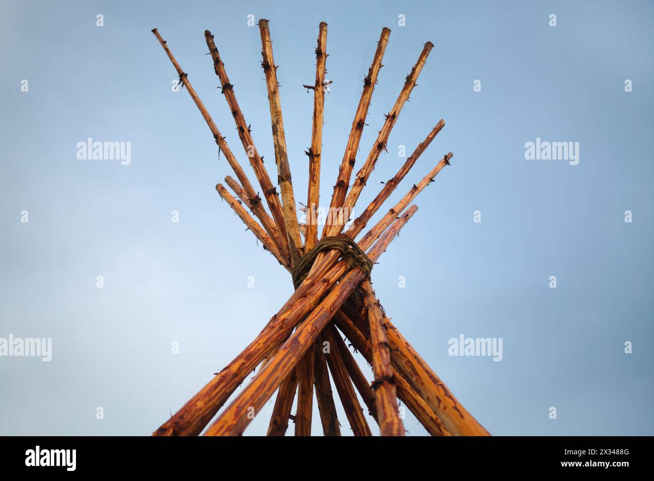 Tipi on blue sky background (Tipi - structure in shape of cone, which ...