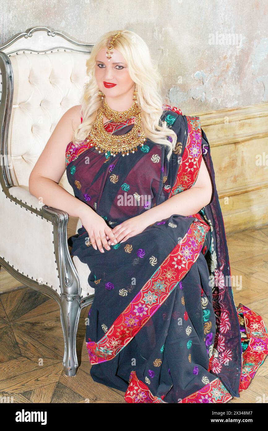 Stout blonde woman with golden decorations on head dressed in beautiful ...