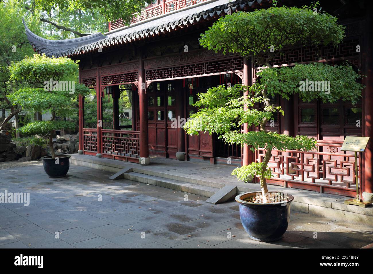 Beautiful chinese garden with gnarled trees and old buildings at sunny ...