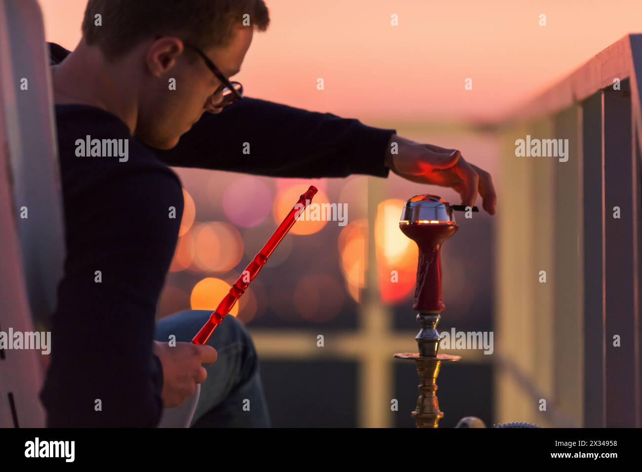Young man smoking hookah in hi-res stock photography and images - Alamy