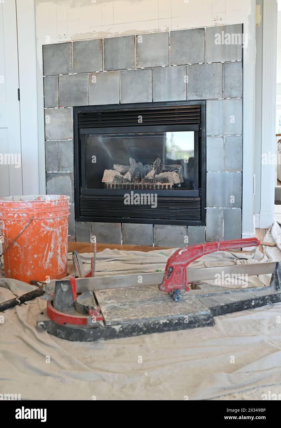 Home renovation project in progress, weekend tiling to update fireplace ...