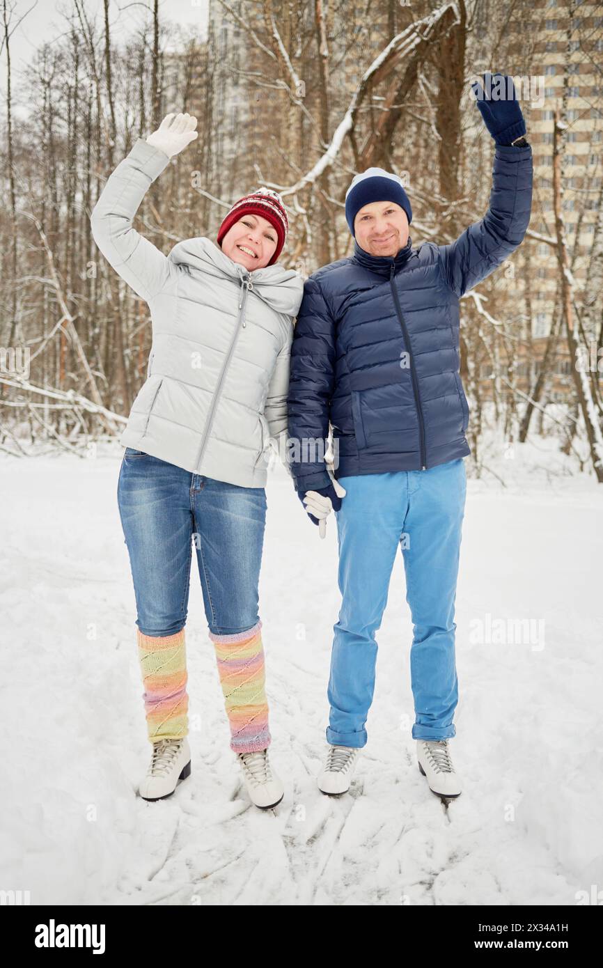 Cheerful young couple waving hands hi-res stock photography and images ...