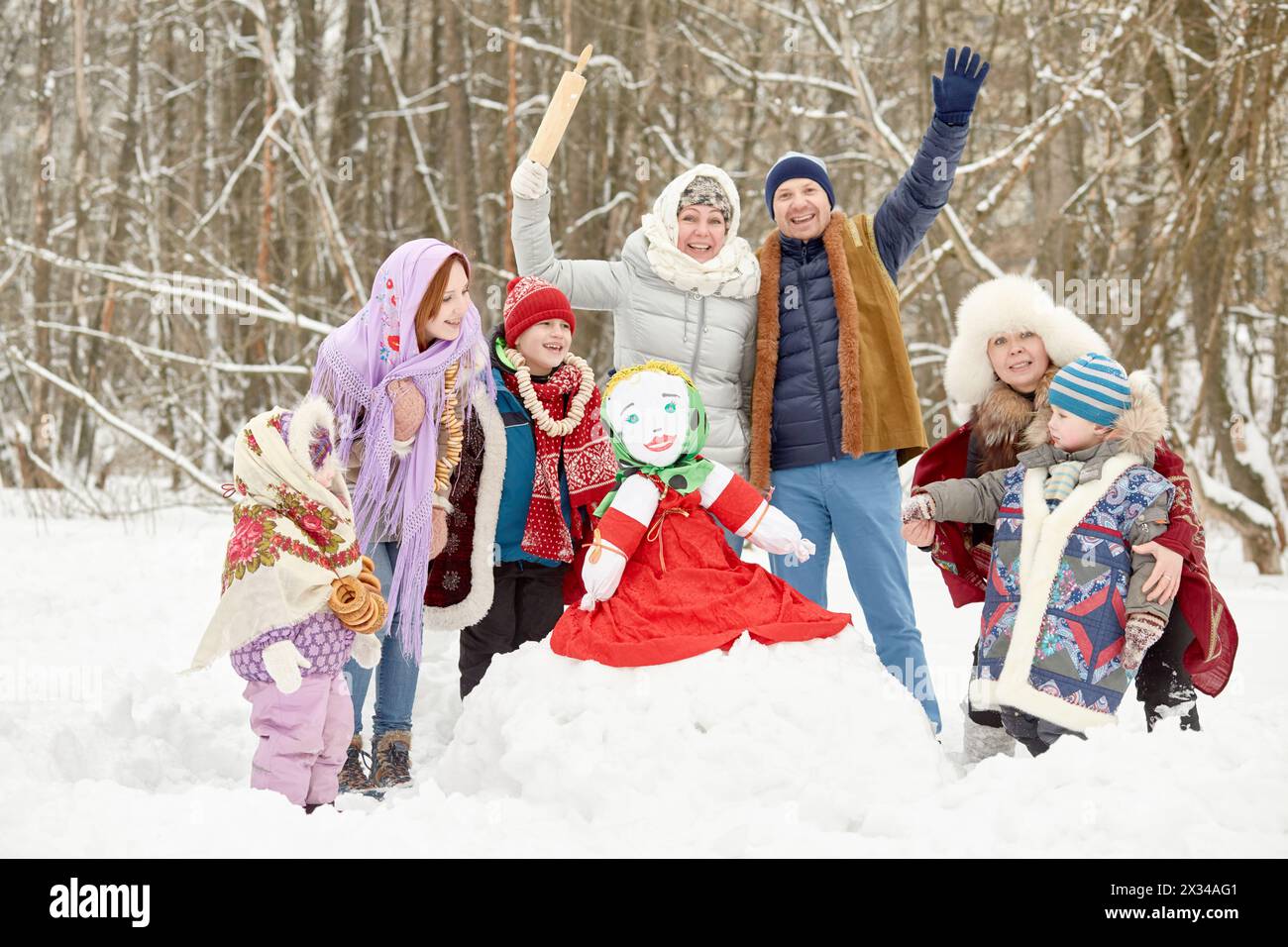 Three adults and four children around stuffed dummy Maslenitsa in ...