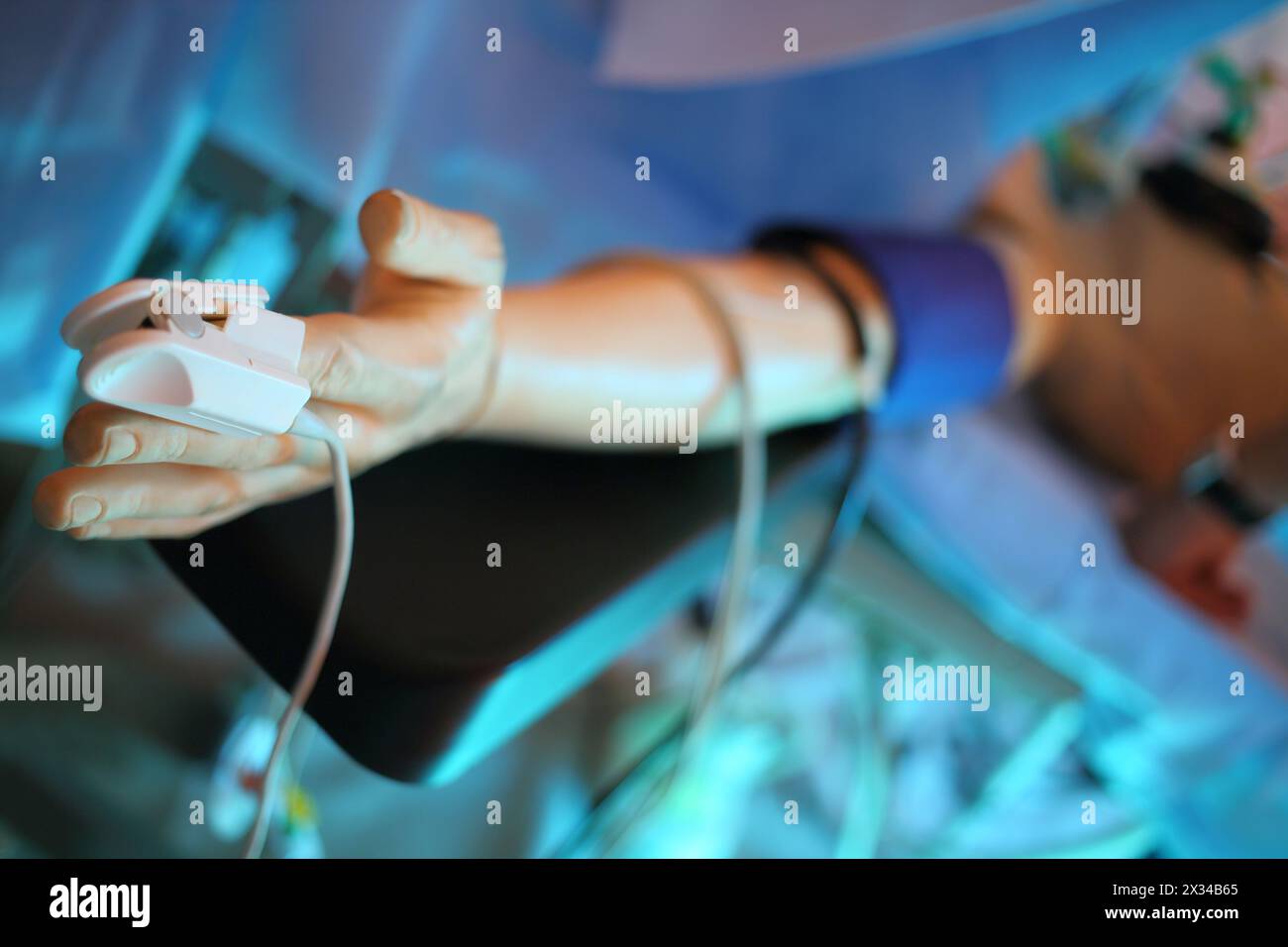 Dummy hand with a sensor for pulse oximetry on finger on the surgical ...