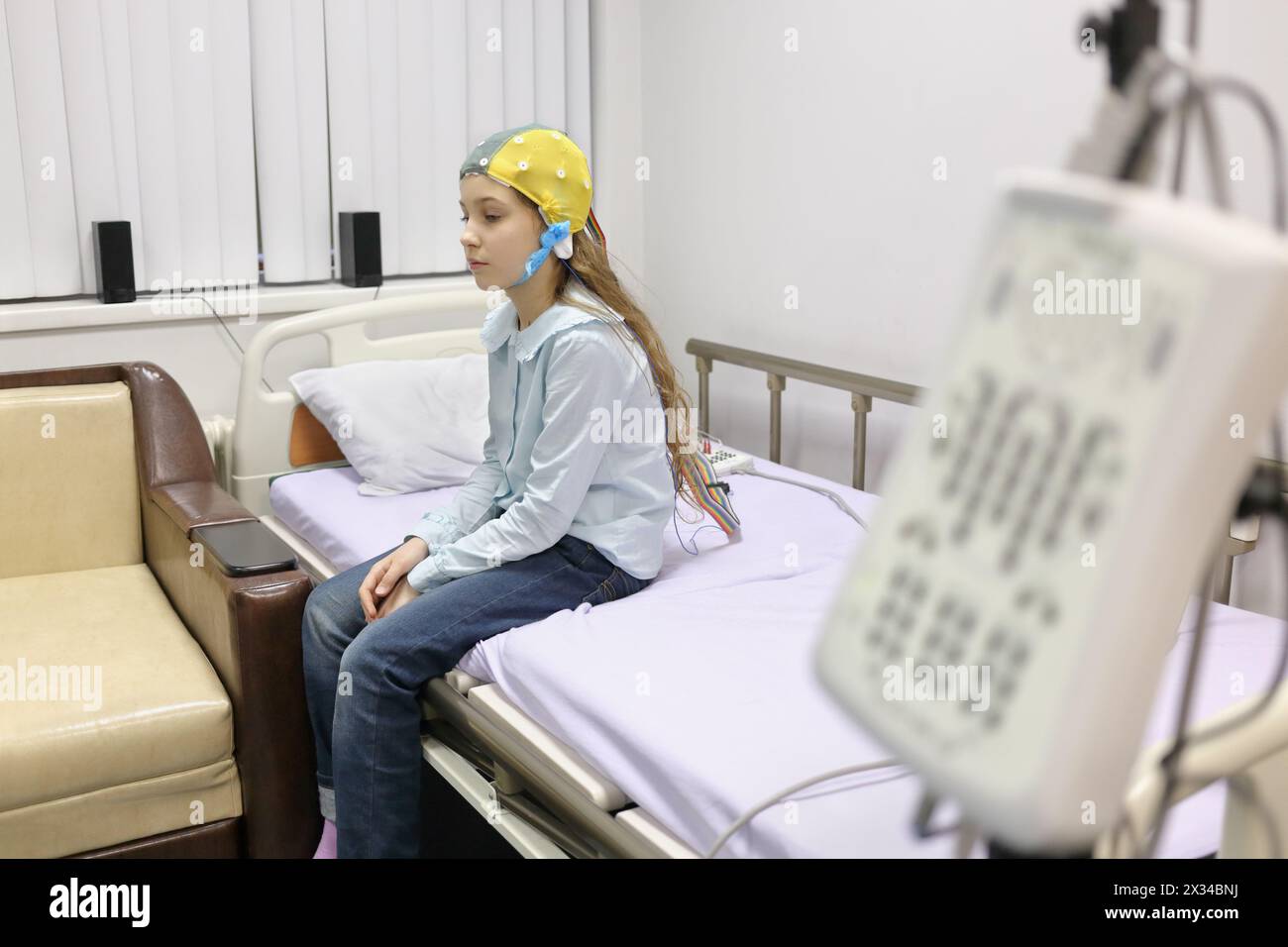 patient girl on procedure of removing of electroencephalogram, sitting ...