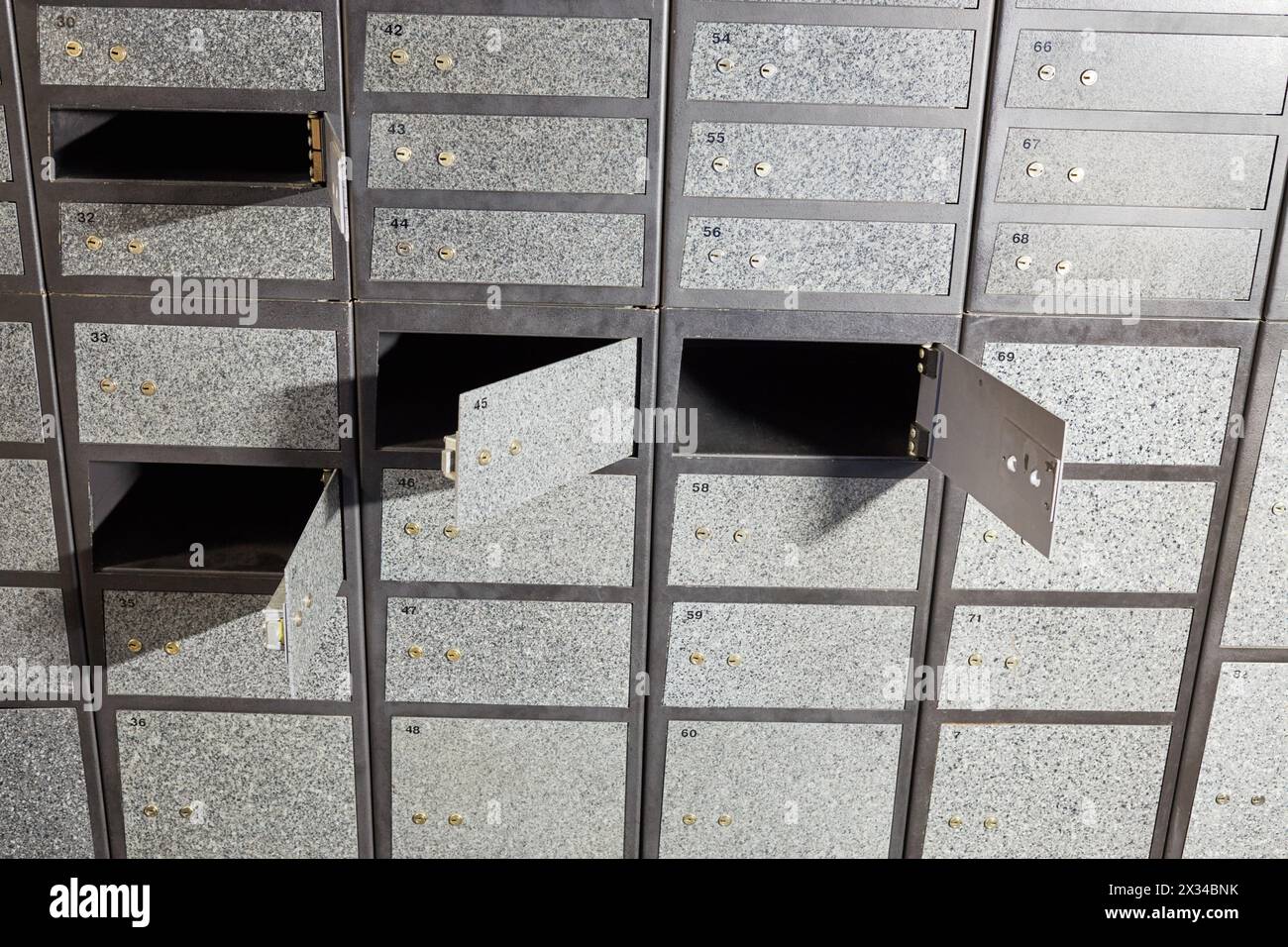 Set of numbered metal boxes with doors with two locks Stock Photo - Alamy