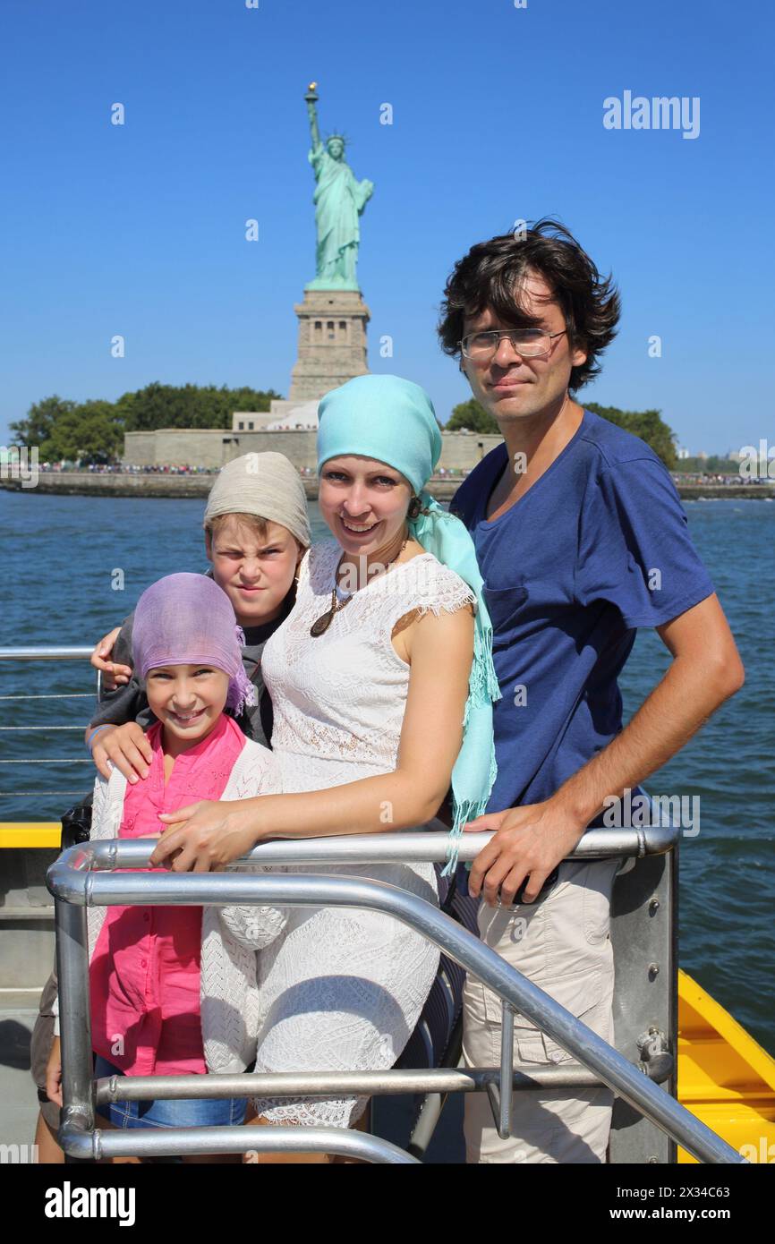 Portrait of parents with their son and daughter on a boat in front of ...