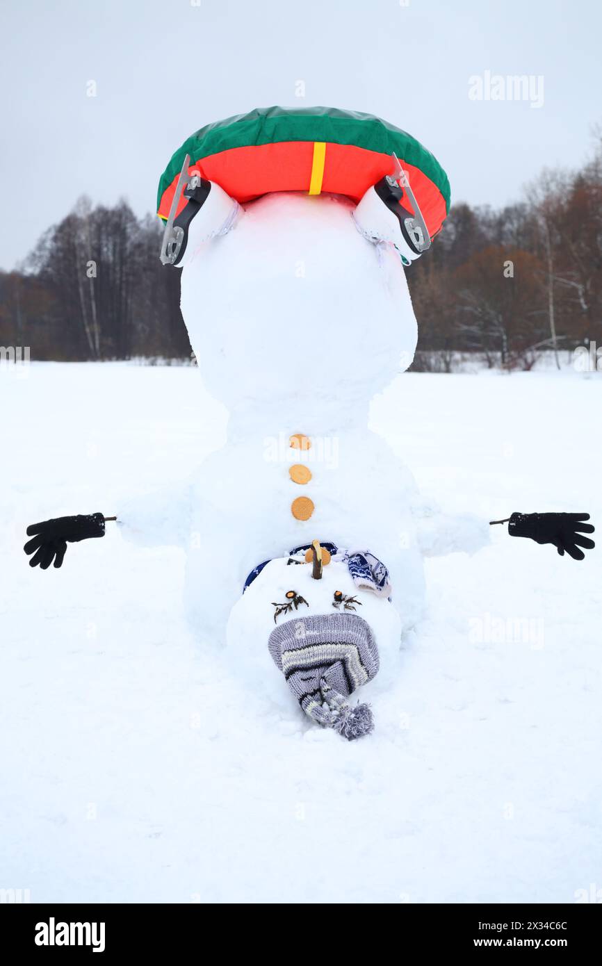 Upside down snowman with hat, snowtube and skates at winter day Stock ...