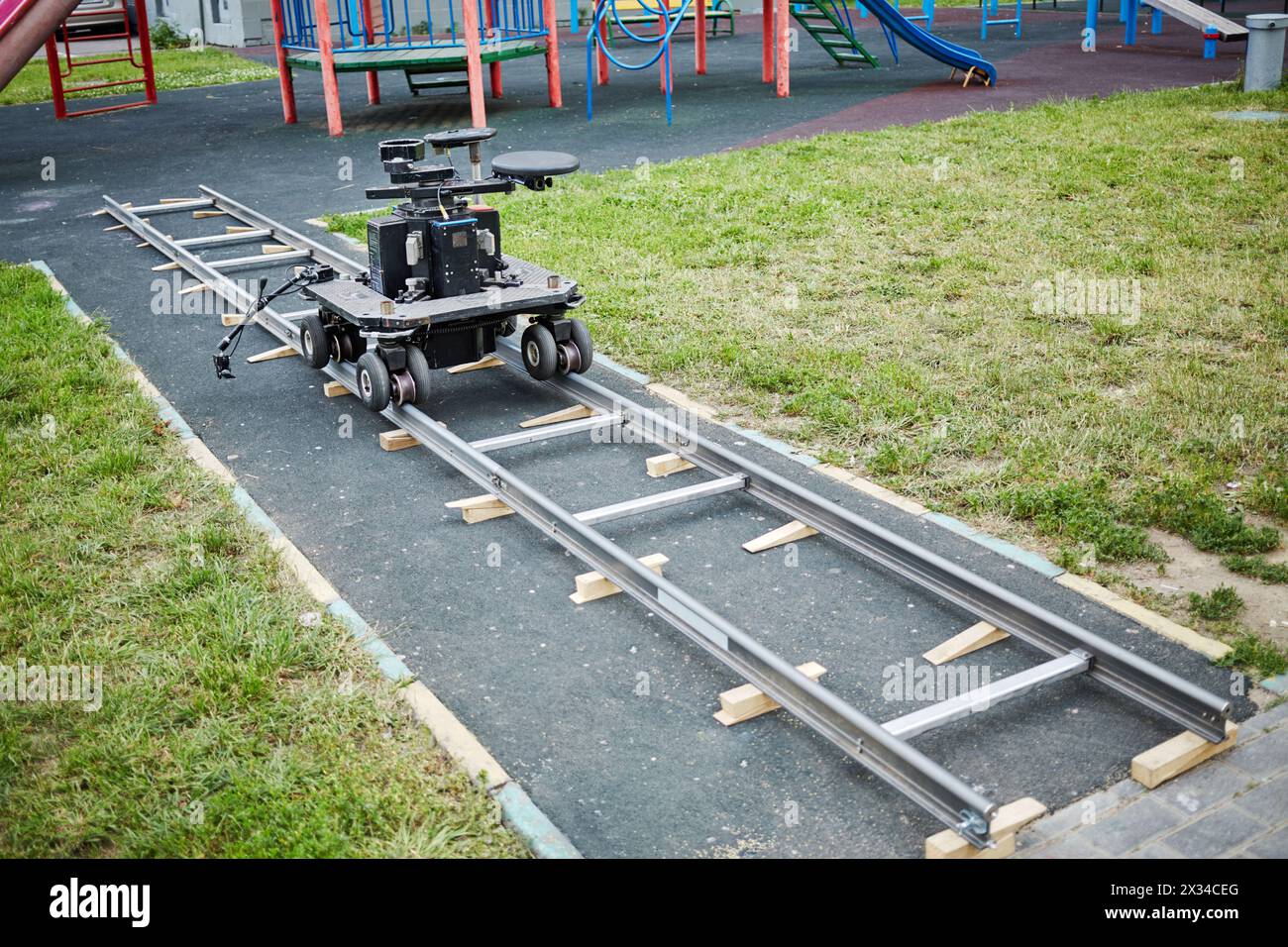 Cameraman dolly stands on rails mounted at children playground Stock ...