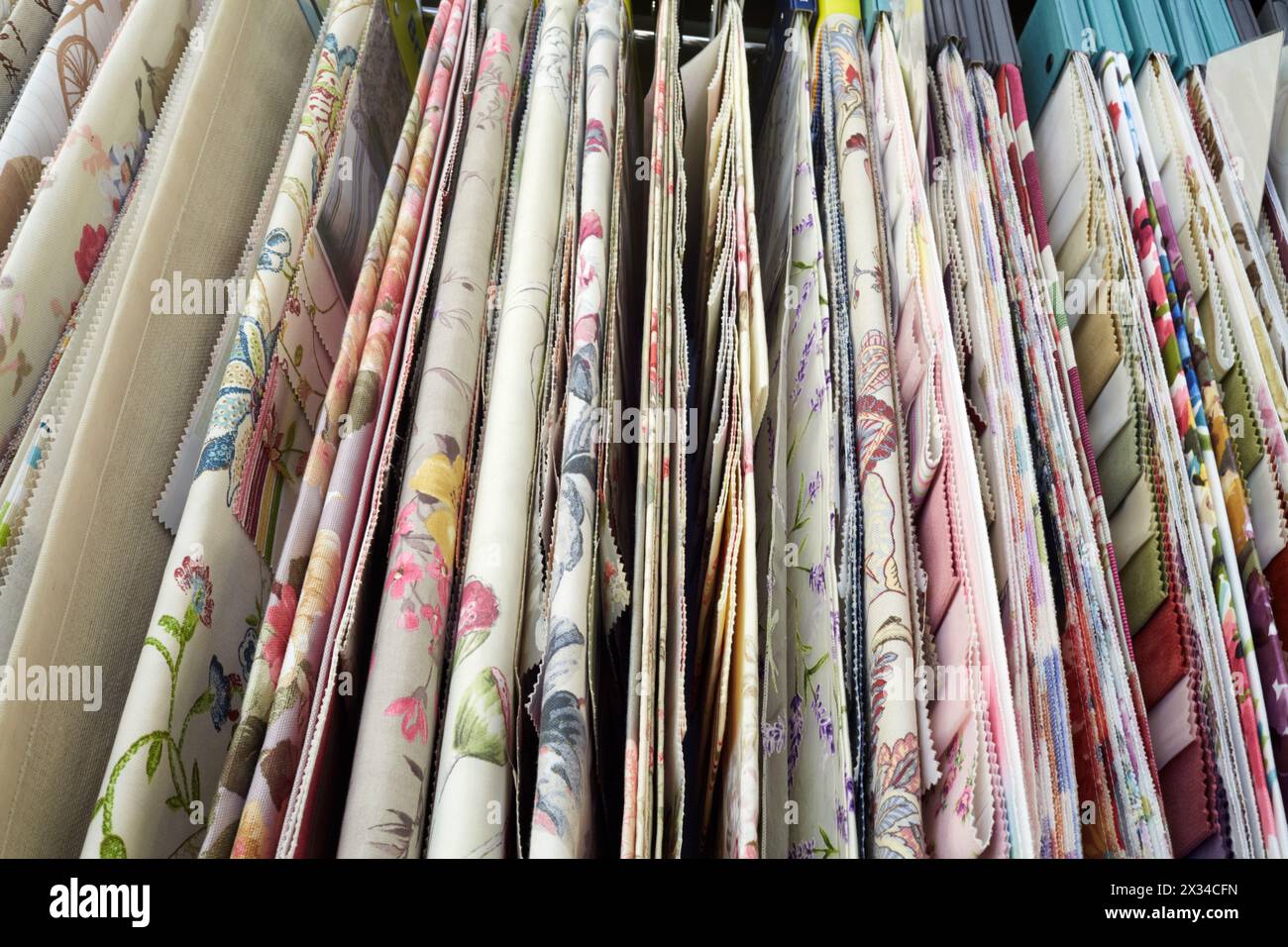 Colorful curtain samples hanging from hangers in a retail store Stock ...