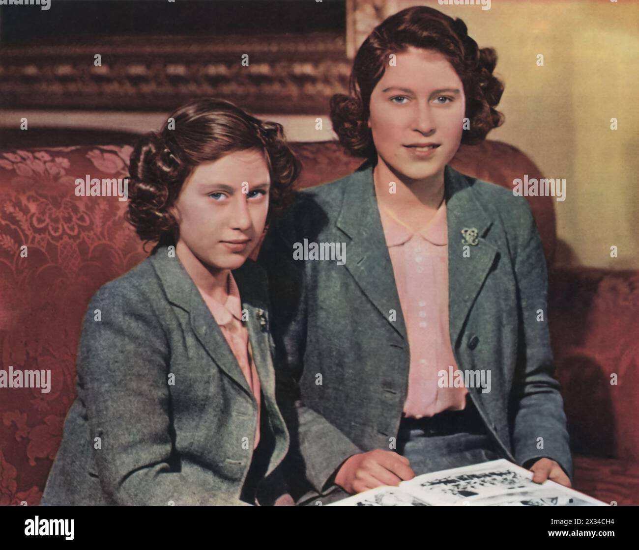 A young Princess Margaret and Princess Elizabeth are shown seated ...
