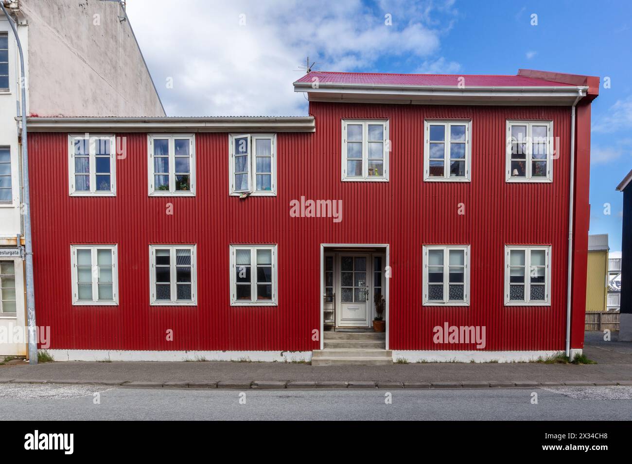 Traditional Icelandic ironclad red residential house with white window ...