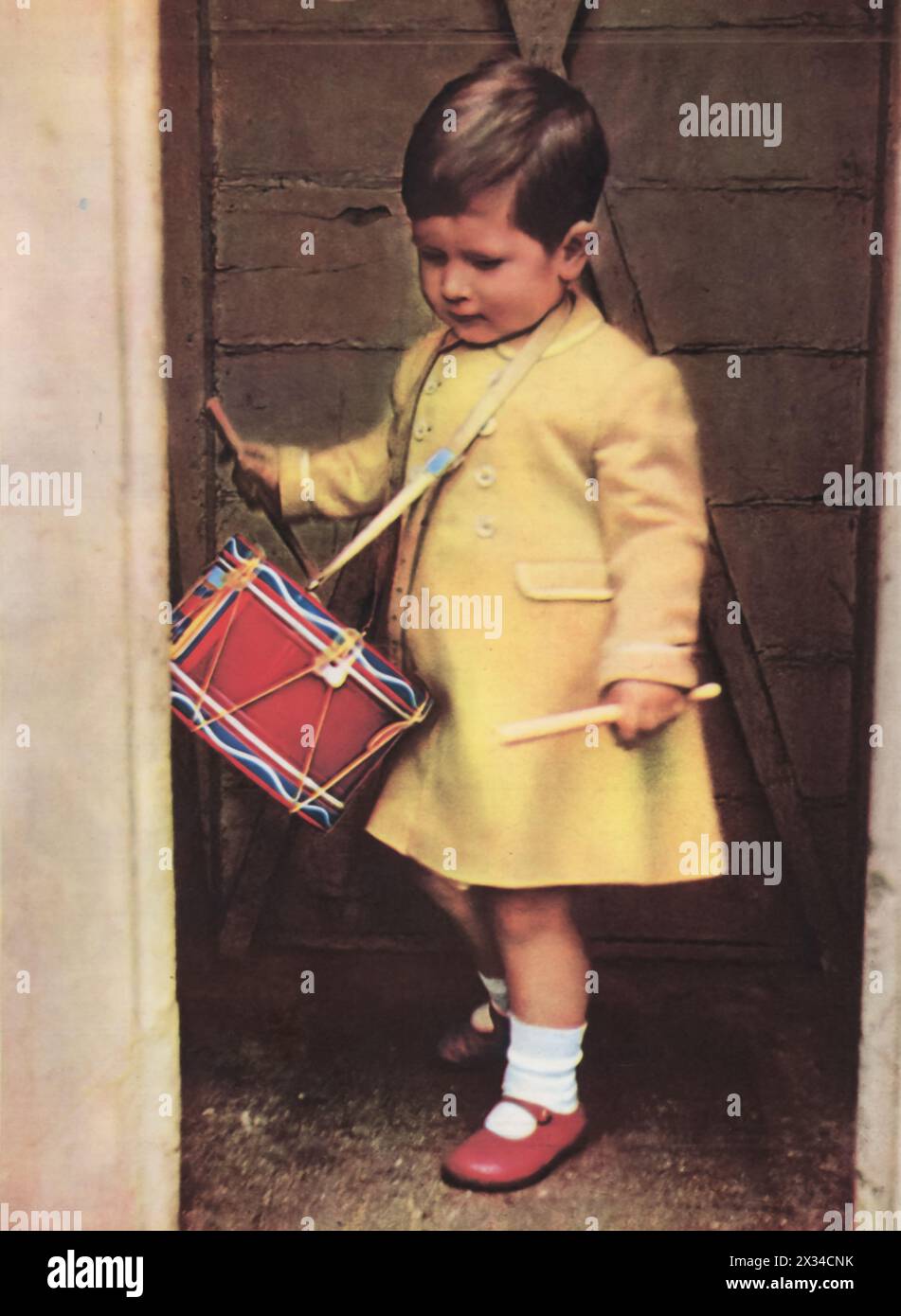 Photograph of a young Prince Charles III is shown playing with his toy ...
