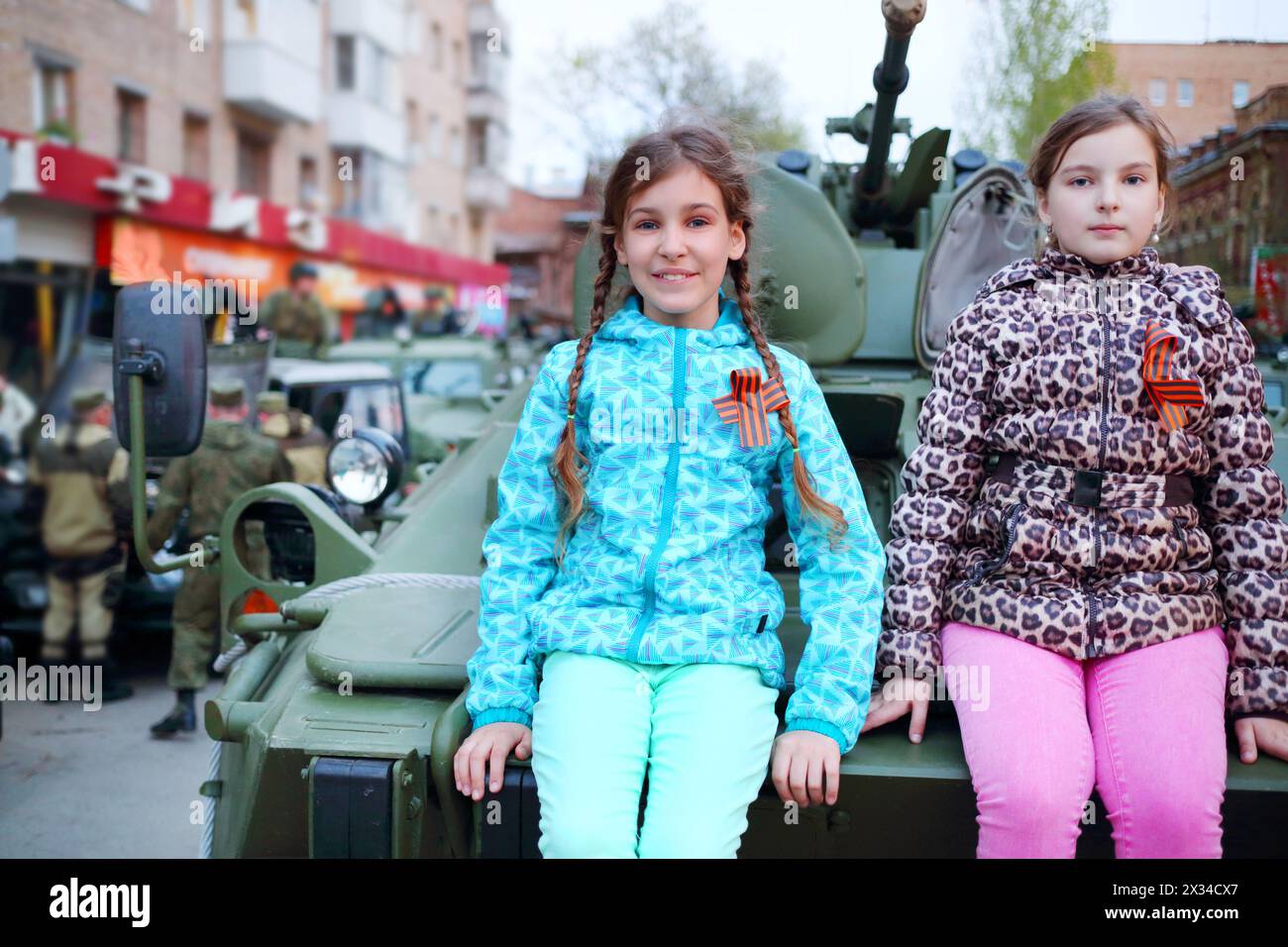 Two girls pose on armored tank in Samara during military parade, Russia ...