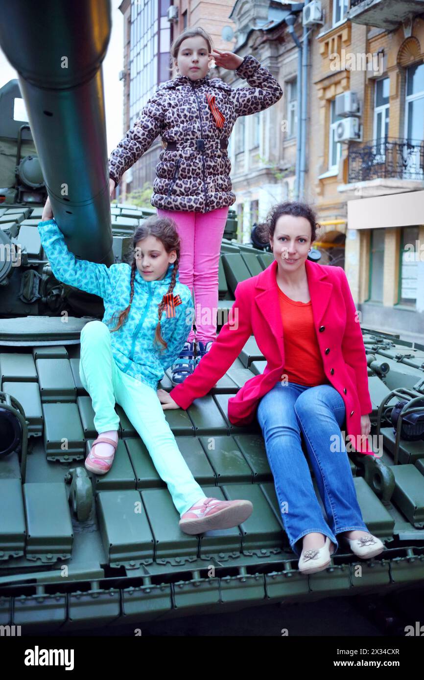 Woman and two girls pose on big armored tank in Samara during military ...