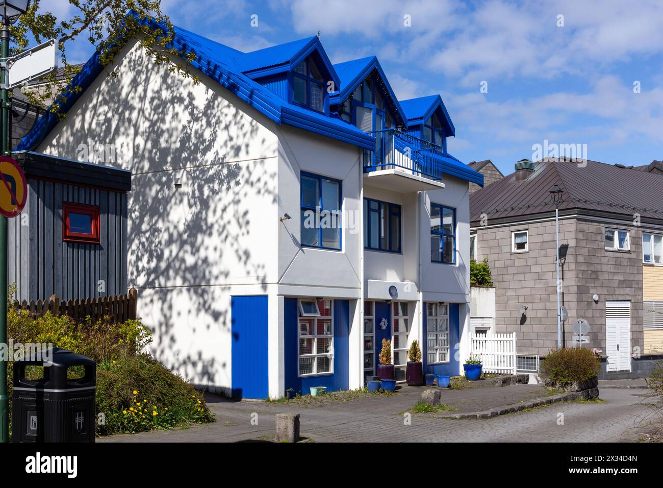 Modern Icelandic house with blue gable roof, white stone facade and ...