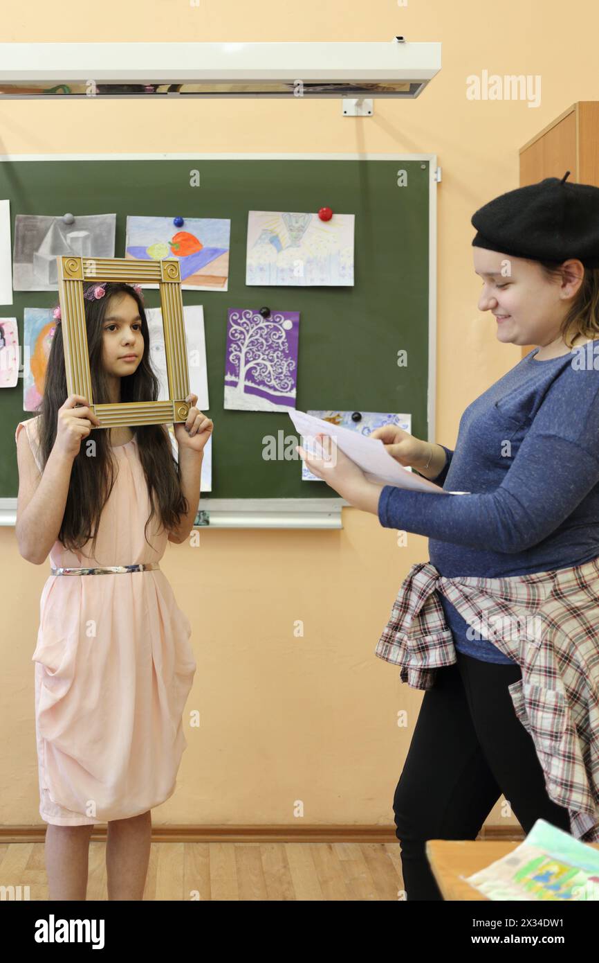 Two student act out scene in class performance at drawing lesson, focus ...