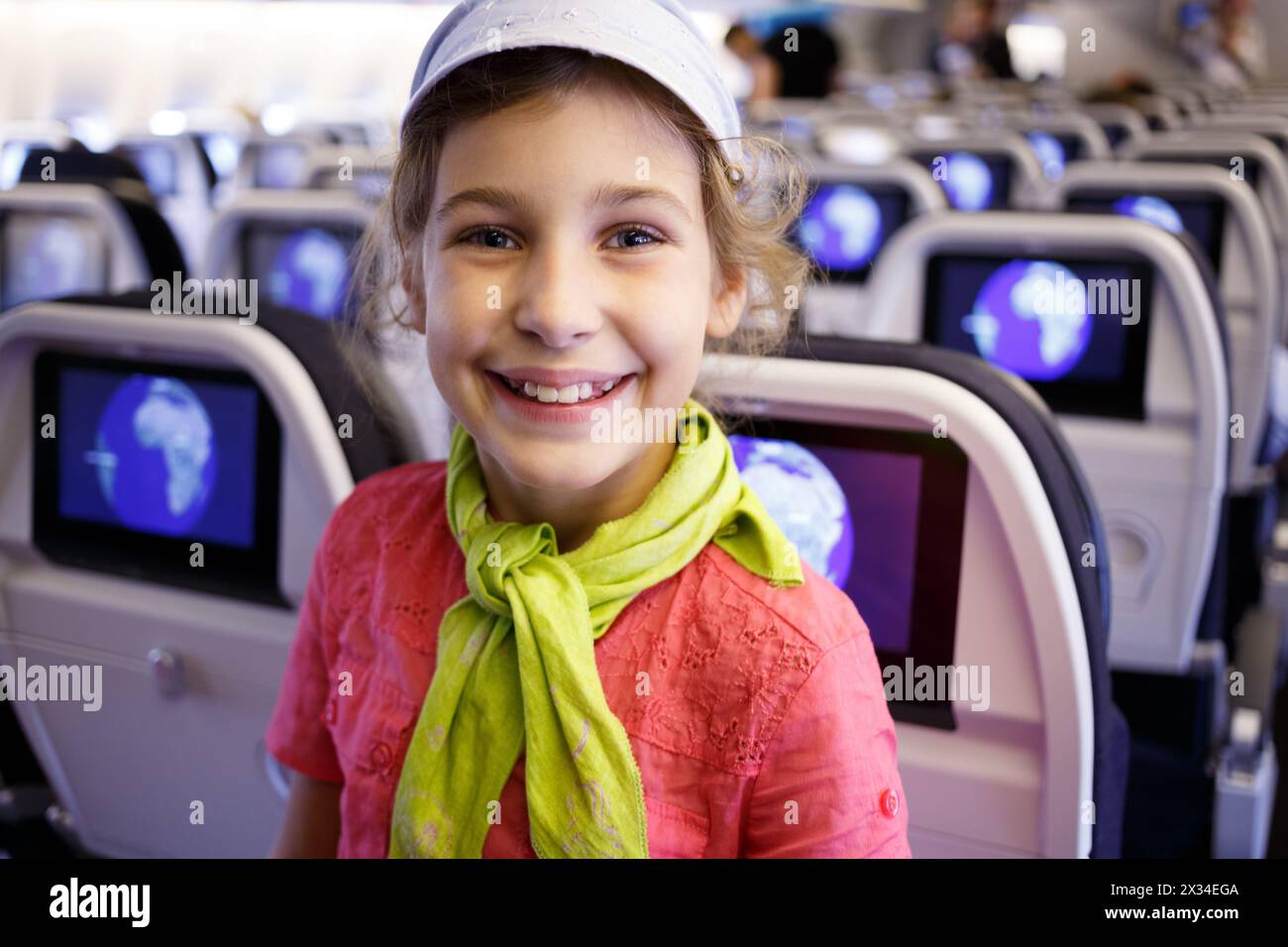 girl in an airplane cabin on a background of screens in seatback Stock ...