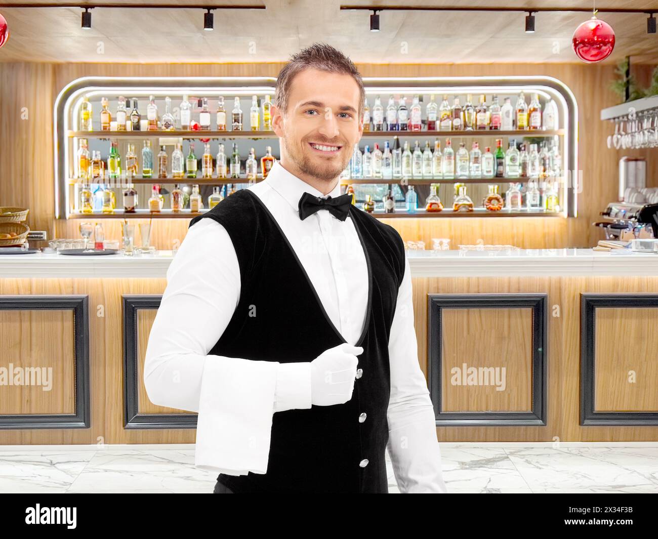 Professional waiter with a towel around his arm at a hotel bar Stock ...