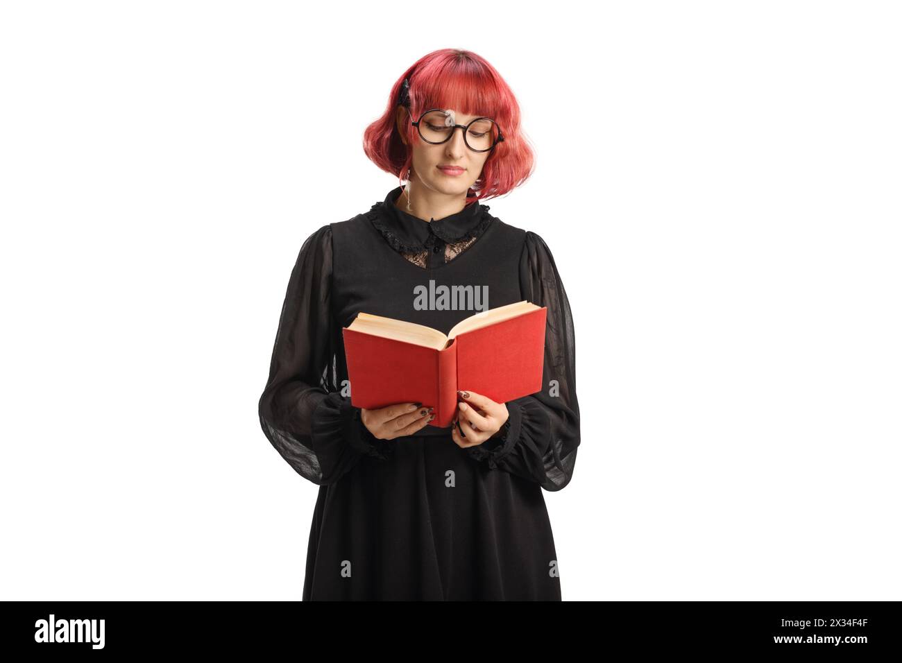 Young woman in a black dress holding a book isolated on white ...