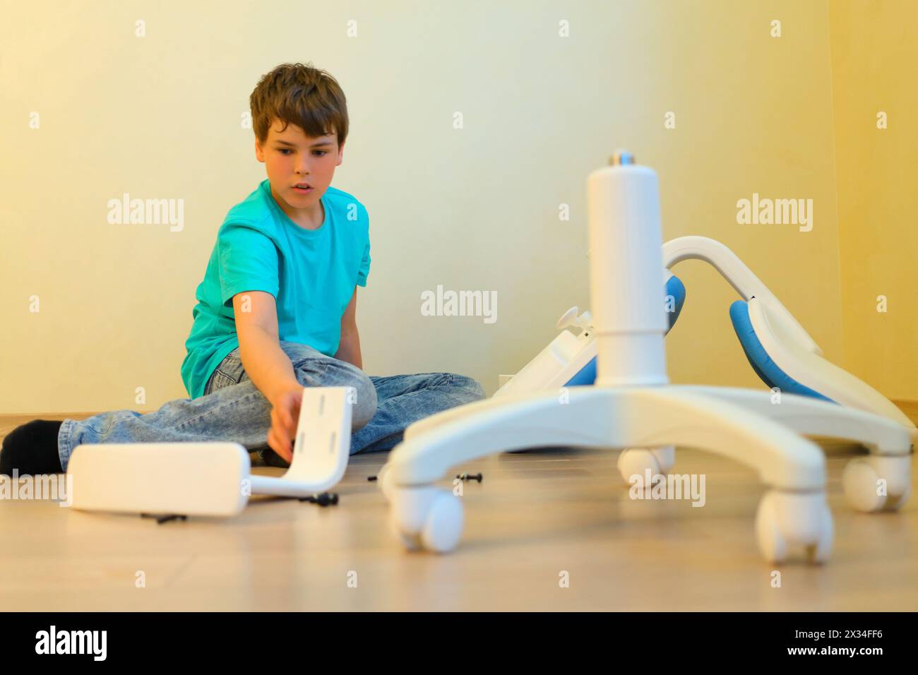young boy assemble parsed chair in apartment sitting on floor Stock ...