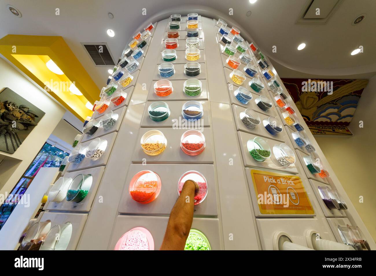 NEW YORK - August 23, 2014: man hand picking bricks at Lego store in ...