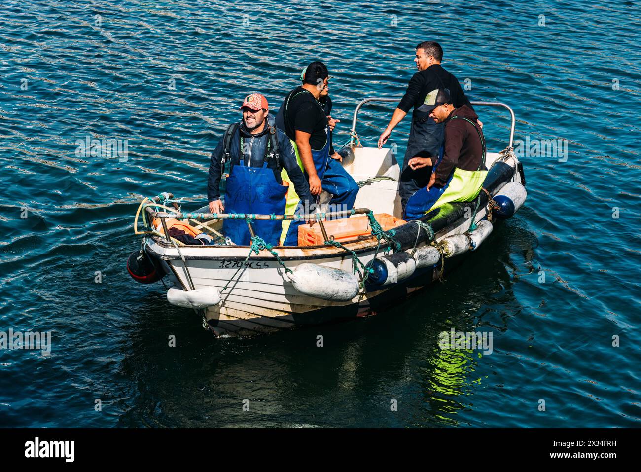 Cascais, Portugal - April 24, 2024: A trio of fishermen are aboard a ...