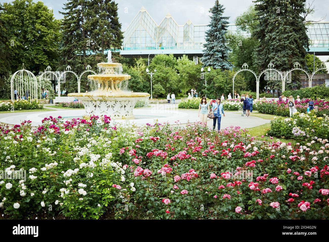 MOSCOW, RUSSIA - JUN 29, 2015: People walk in rosary near fountain in ...