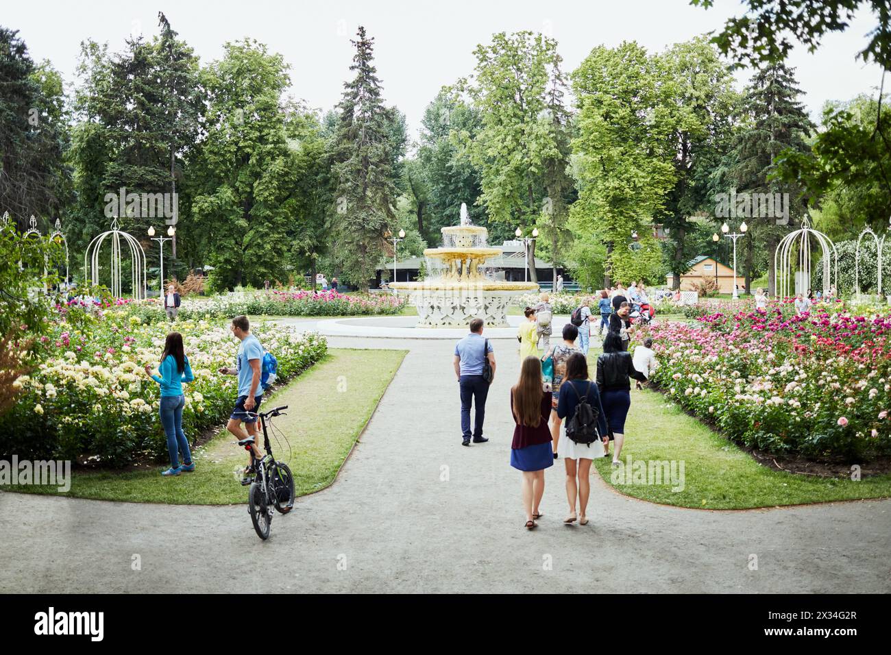 MOSCOW, RUSSIA - JUN 29, 2015: People walk in rosary near fountain in ...
