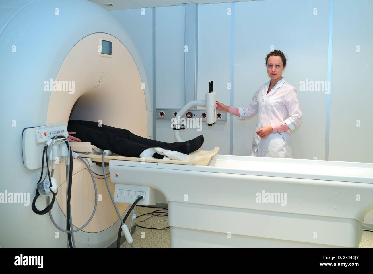 CT (computer tomography) scanner with radiologic technician and male ...