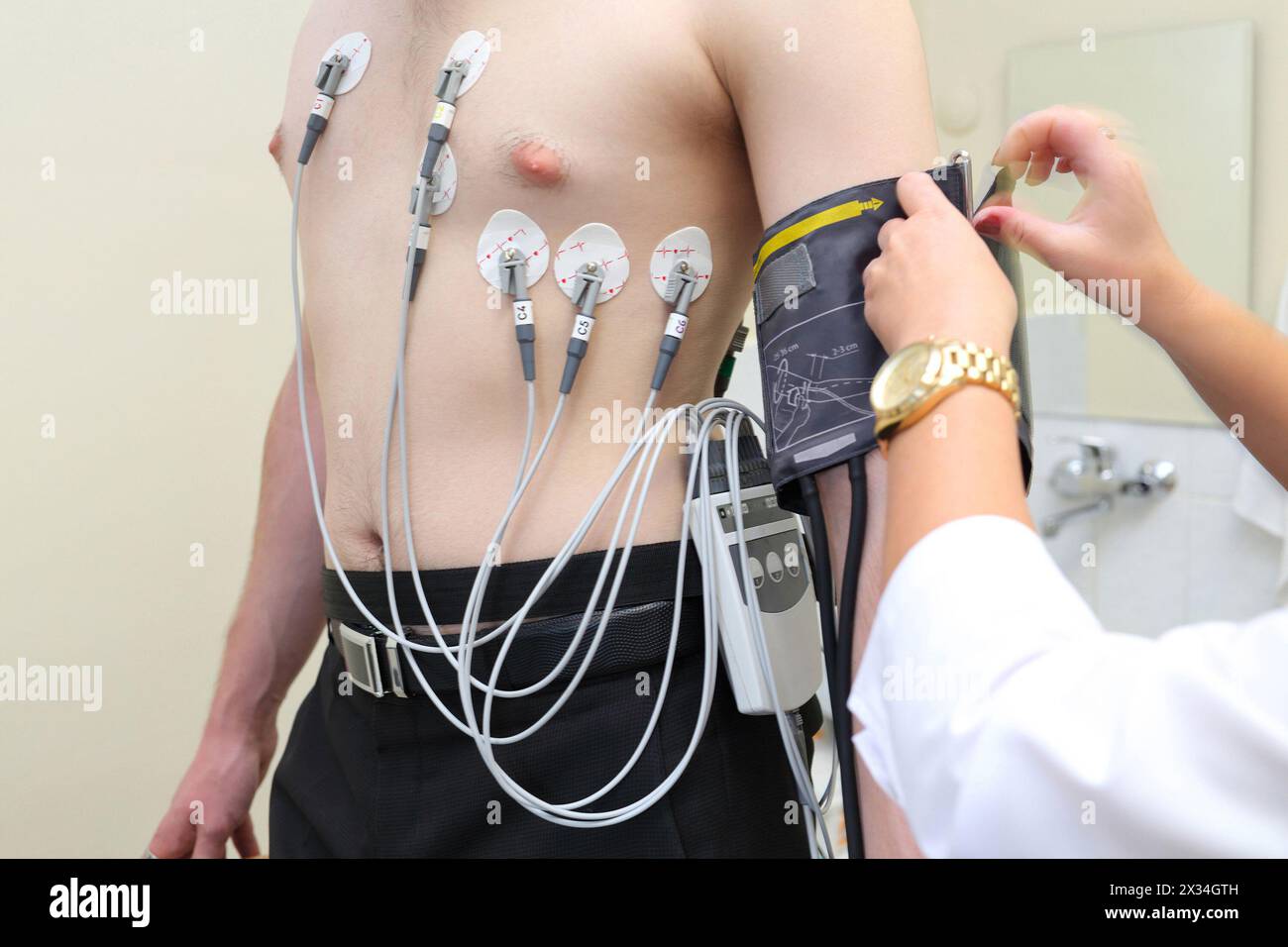 Рatient with ECG electrodes on chest and an instrument for measuring ...