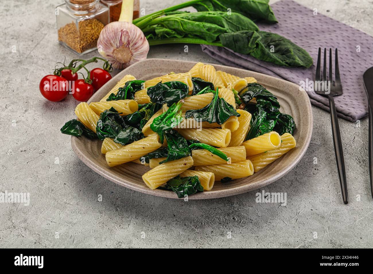Italian cuisine - pasta tortiglioni with spinach Stock Photo - Alamy