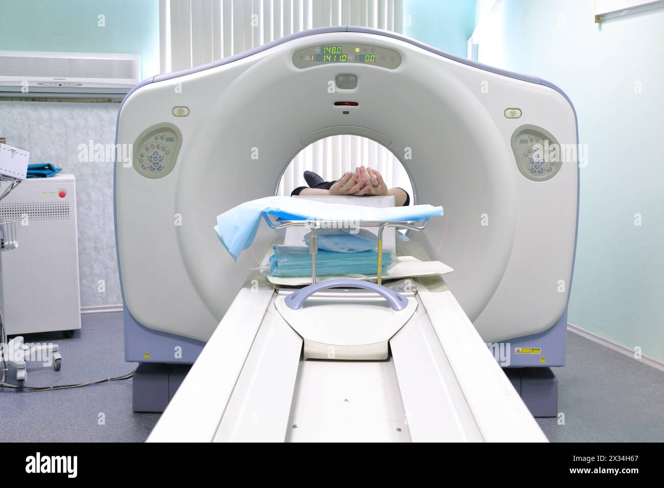 Patient being scanned and diagnosed on CT (computed tomography) scanner ...