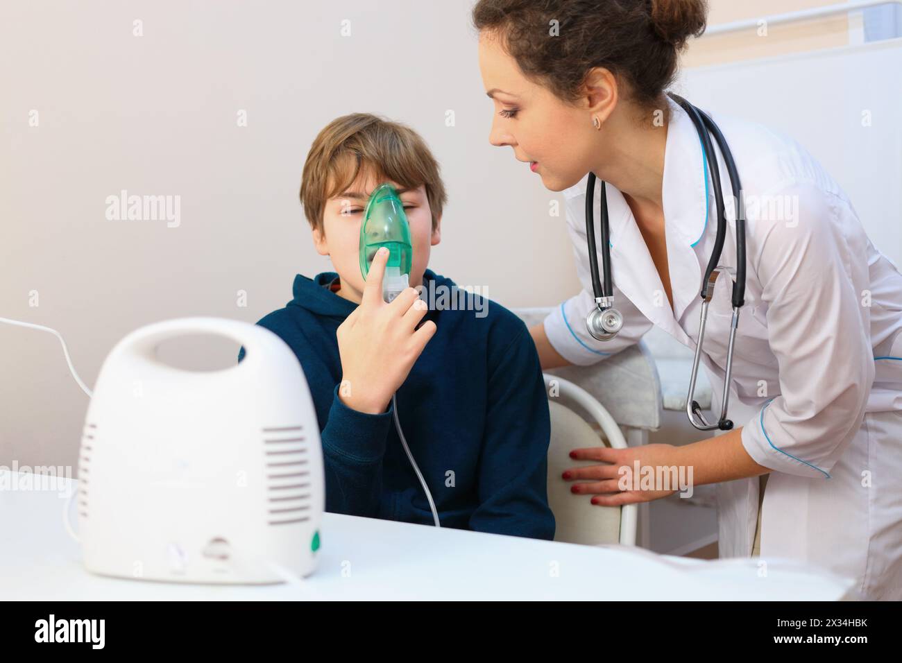 Young boy and health worker making inhalation with nebuliser in exam ...