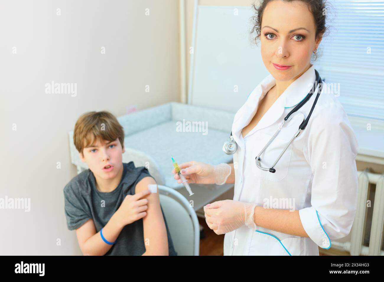 young boy rubbing tissue paper on his hand before injection and health ...