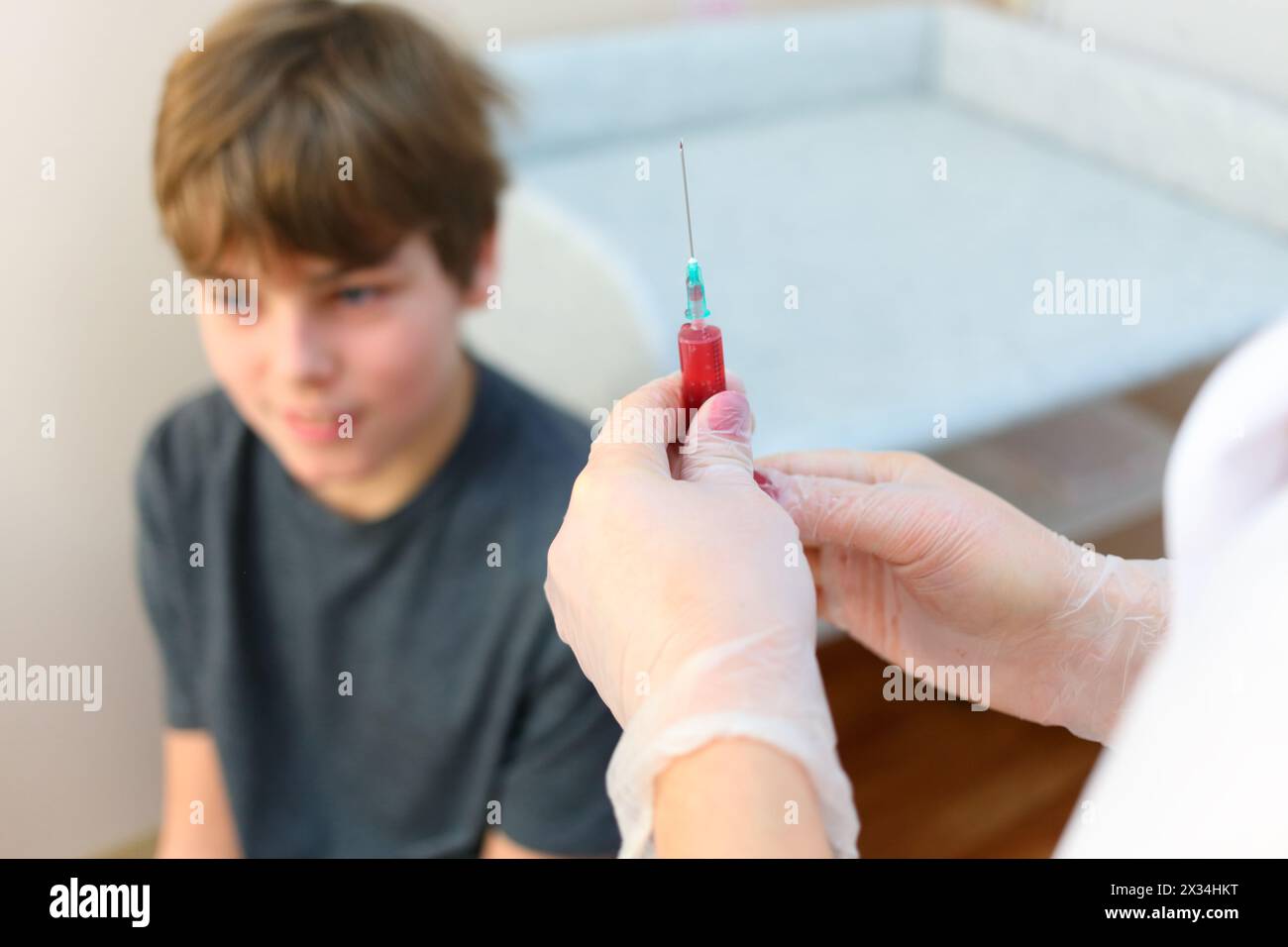 Woman hands holding a syringe with medicine for injection medicine, boy ...