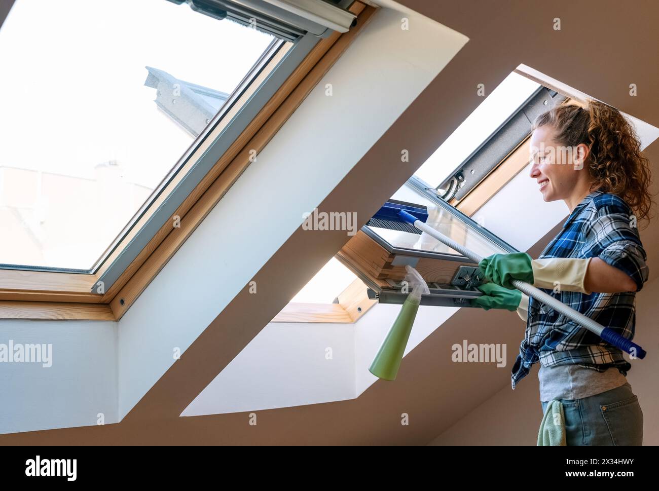 Housework and home lifestyle. Woman washes windows in her apartment ...