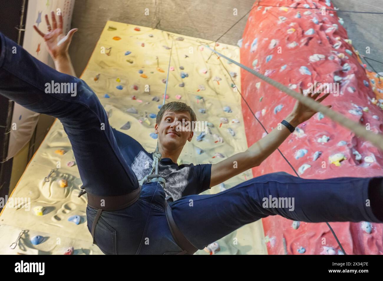 Couple rock climbing hanging from rope hi-res stock photography and ...