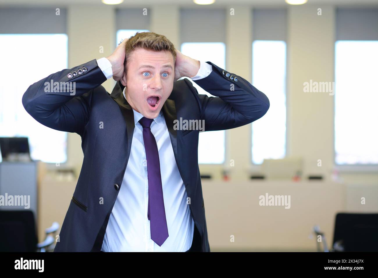 Very frightened businessman clutched his head in office Stock Photo - Alamy
