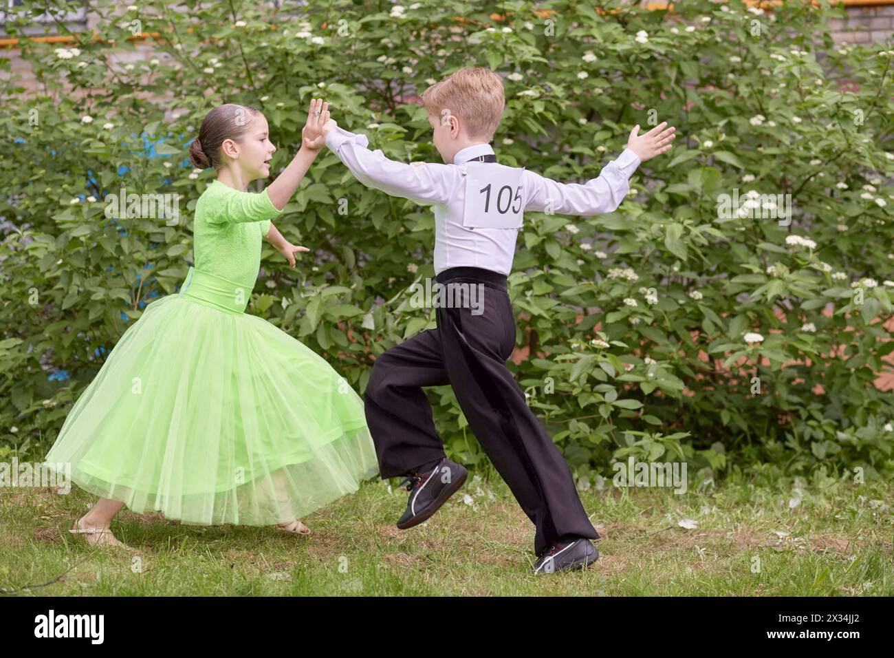 Children couple dances ballroom dance outdoor at grassy lawn Stock ...