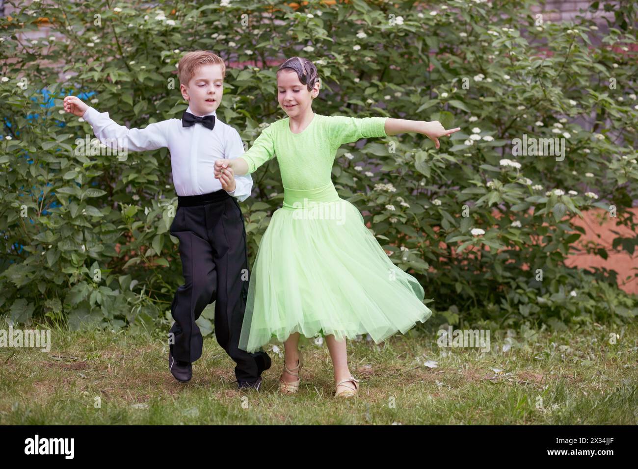 Children couple dances ballroom dance outdoor at grassy lawn Stock ...