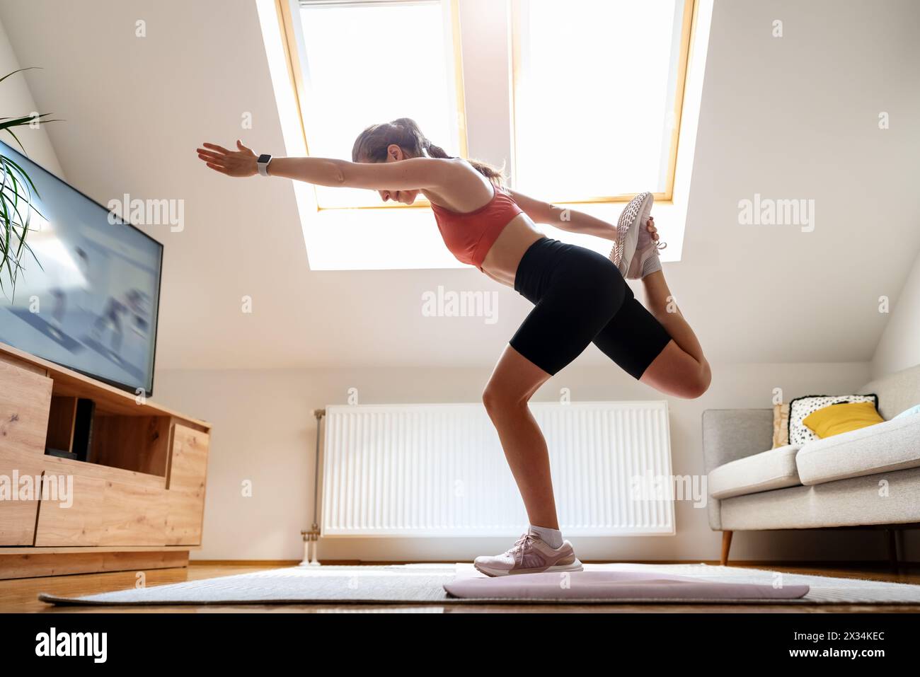 Home fitness. Woman doing workout exercise using video tutorial ...