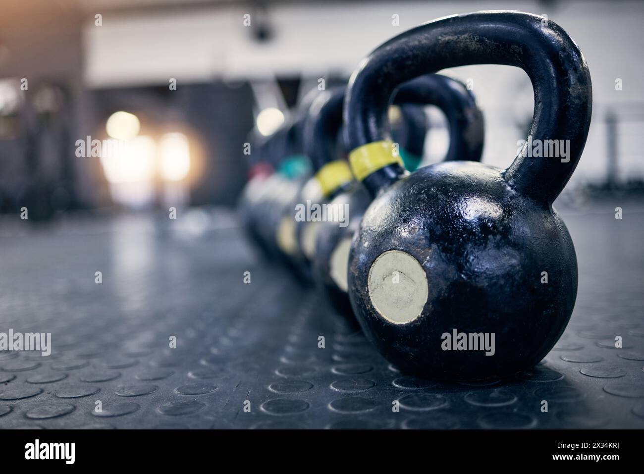 Exercise, kettlebell and weights on floor of gym for training, wellness ...