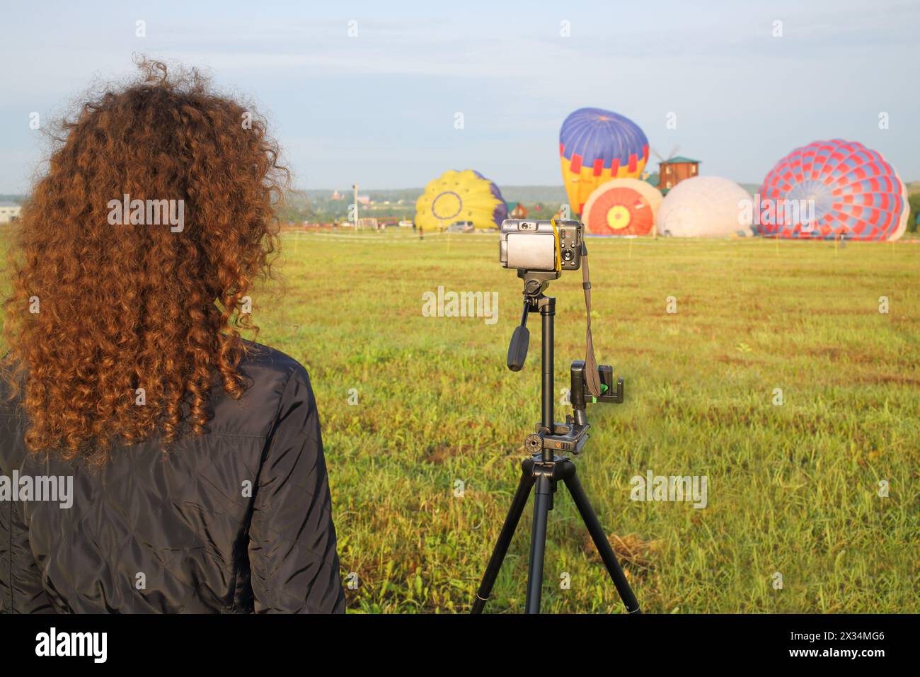 Woman with luxuriant hair shoot at the camera the rise of balloons on ...