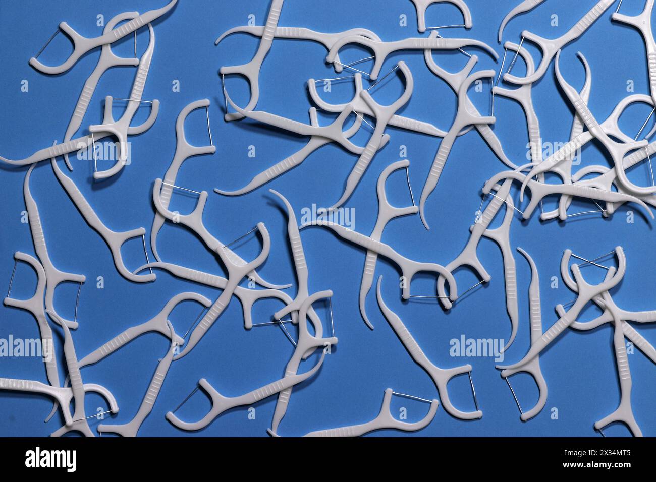 Image of white interdental toothpicks with a thread on a blue ...