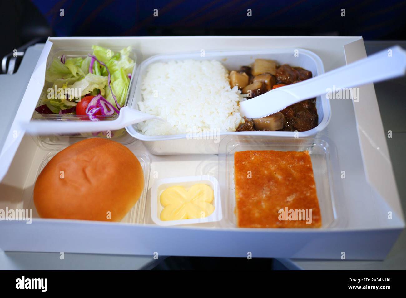 Different meals of breakfast is on table at plane during flight Stock ...