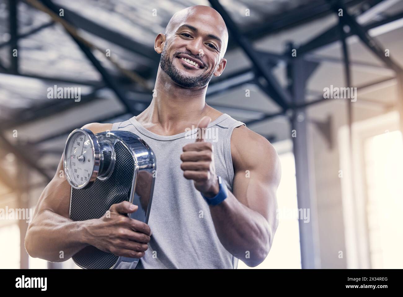 Portrait, scale and thumbs up with bodybuilder man in gym for strength ...
