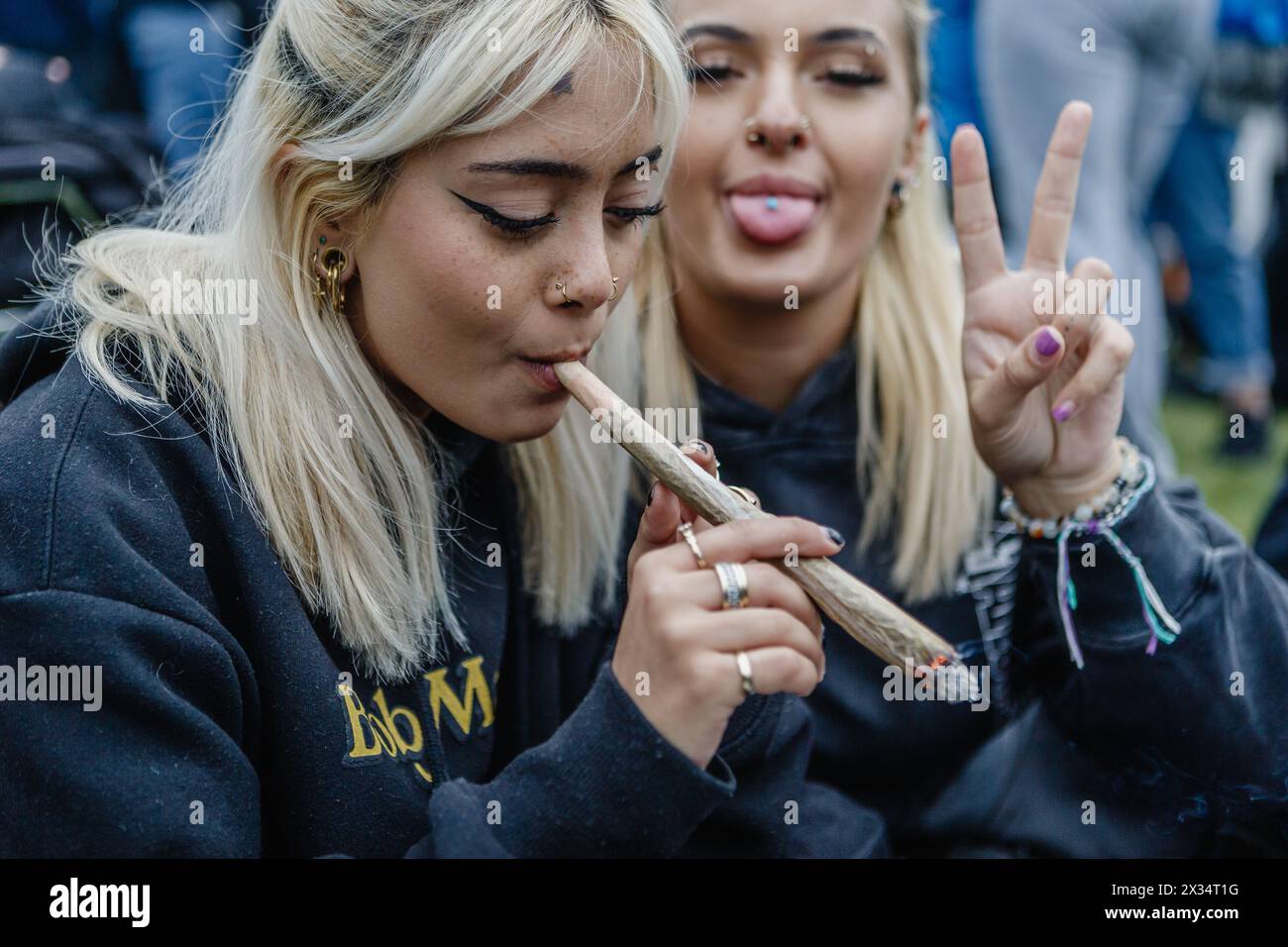 Two girls enjoy a large cannabis joint during the 420 event in London Stock Photo - Alamy